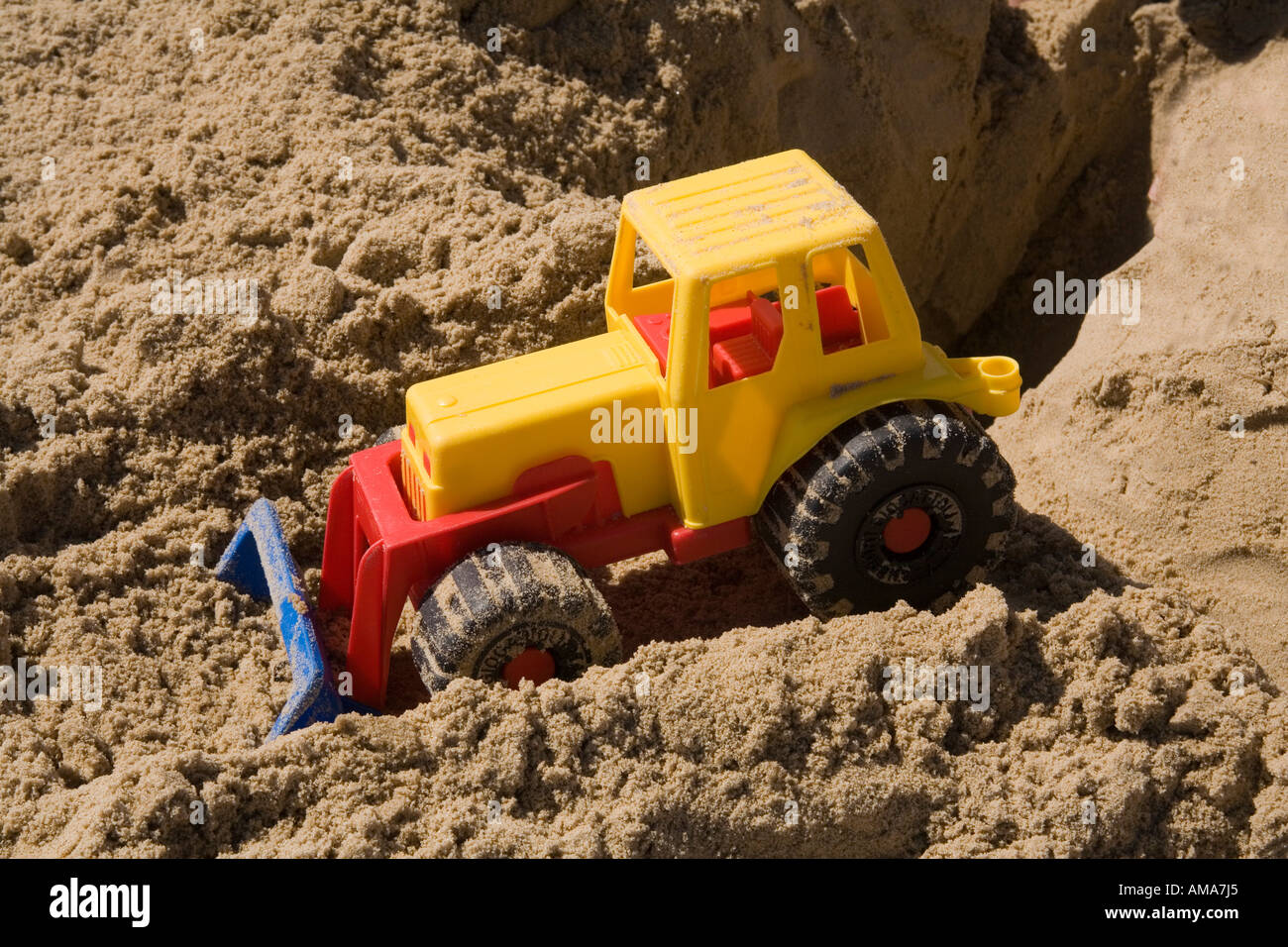 UK Dorset Poole Harbour Sandbanks beach plastic toy digger in the sand ...