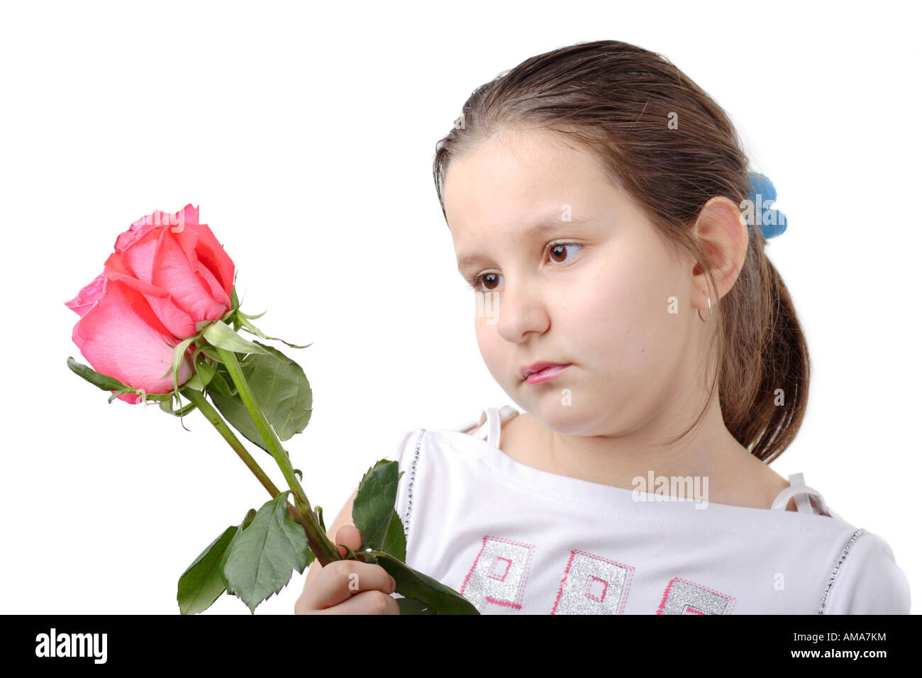 Little sad girl holding flowers Stock Photo - Alamy