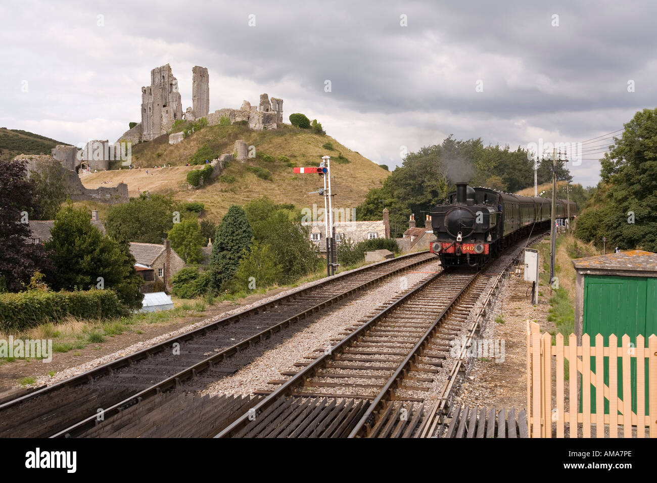 UK Dorset Corfe Castle Swanage Railway stream train arriving at village ...