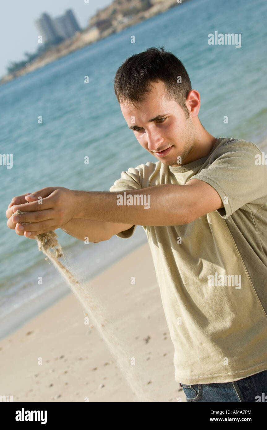Sifting through the sand on the beach hi-res stock photography and ...