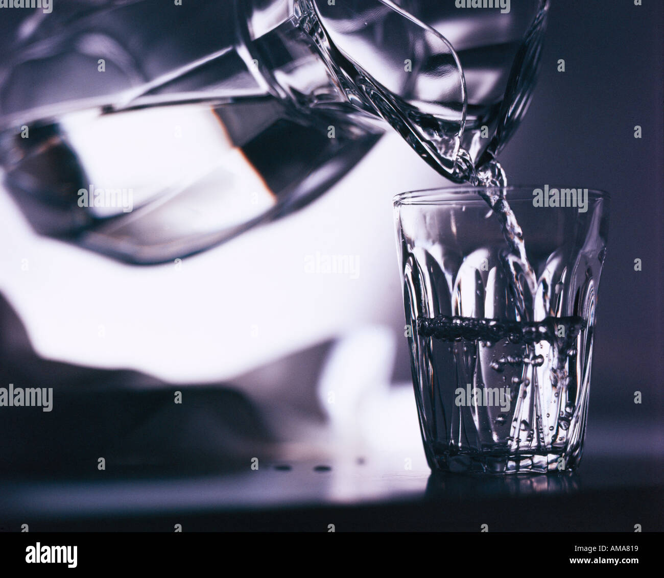 WATER Jug pouring water into glass Stock Photo - Alamy