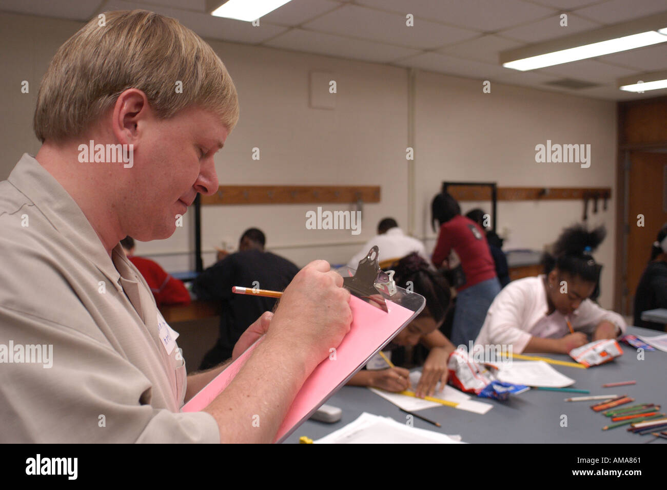 Person with clipboard in classroom hi-res stock photography and images ...