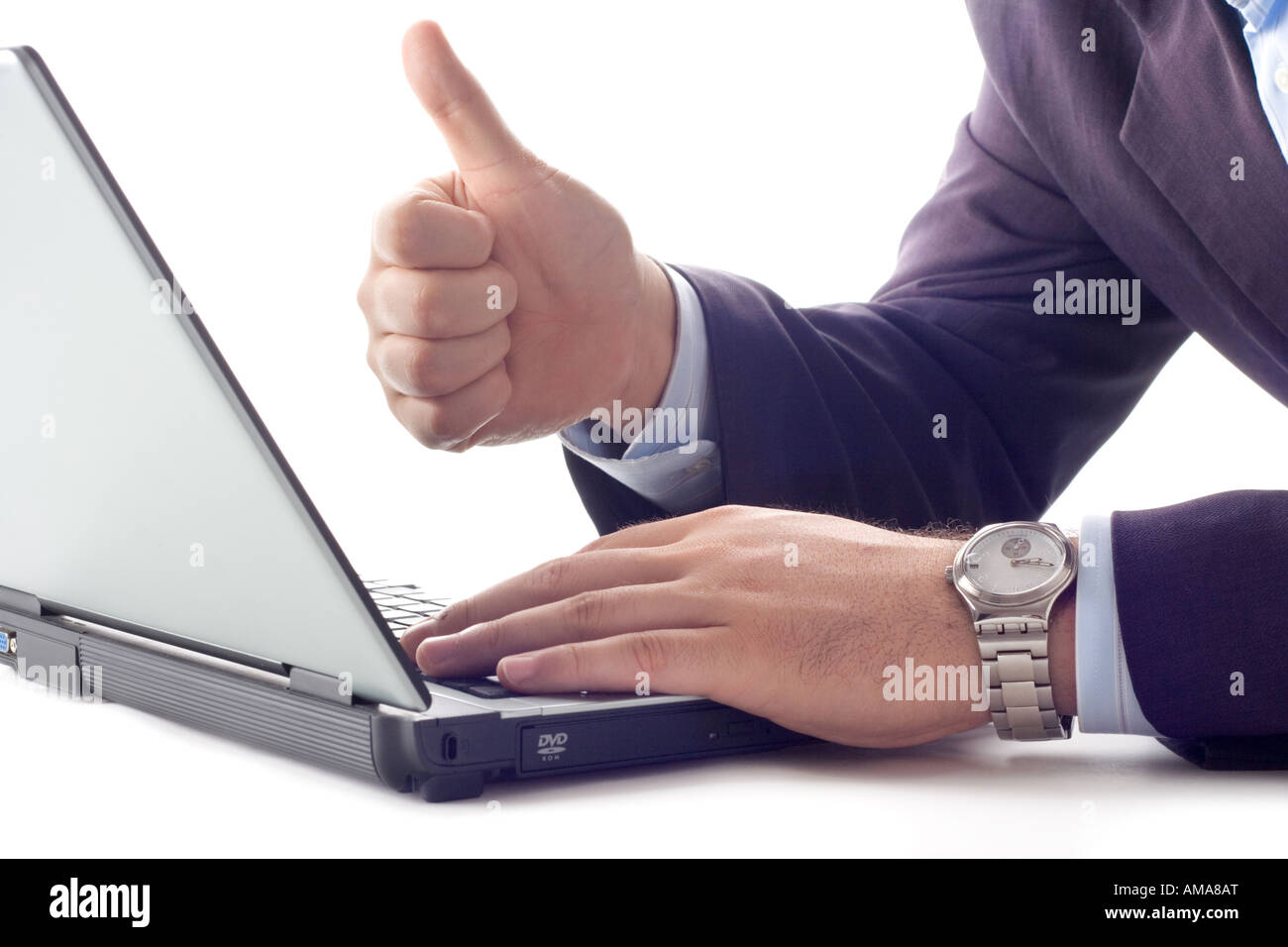 Businessman working on a computer with his thumb up Stock Photo - Alamy