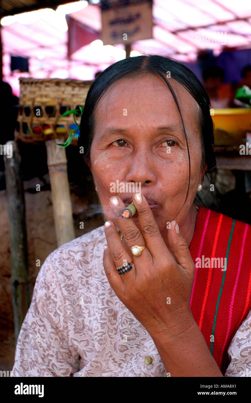 Burmese woman smoking a cheroot at the Phaung Daw U Paya, Inle Lake ...