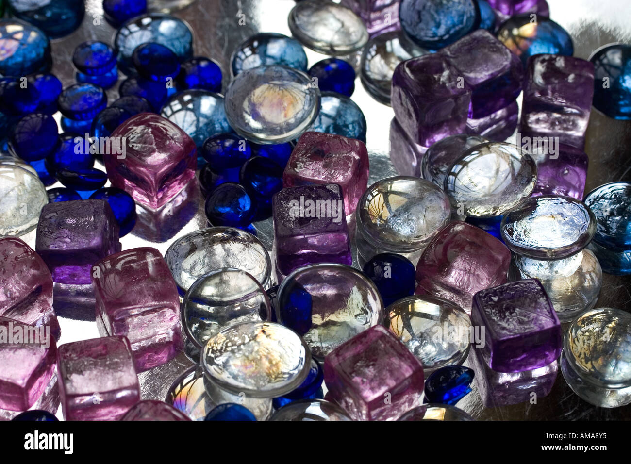 Multicoloured glass shapes on a reflective background (2 Stock Photo ...