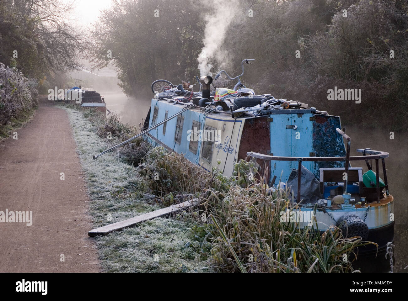 A canalboat moored up on the Kennet and Avon Canal on a cold winters ...