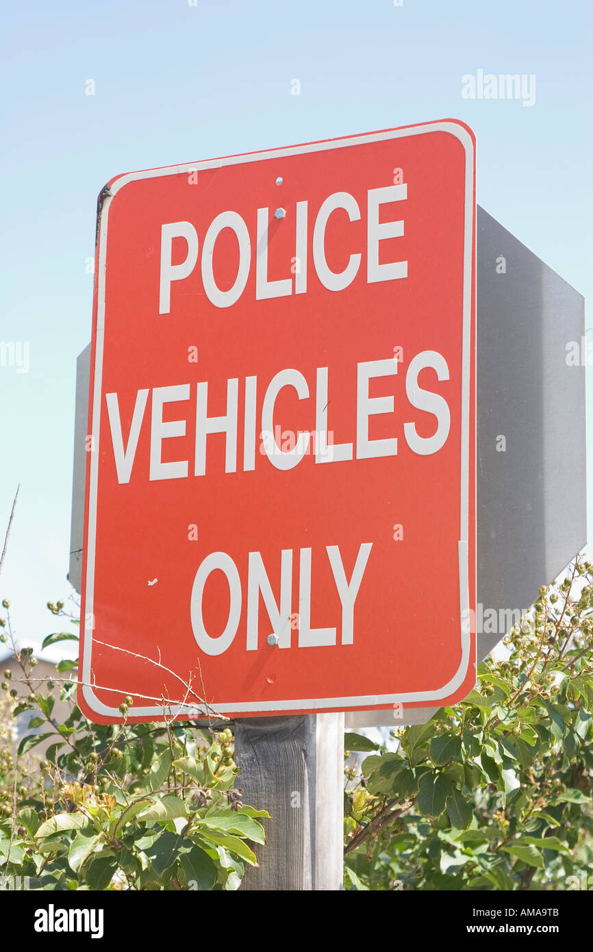 Red sign with white letters at entrance to municipal police department ...