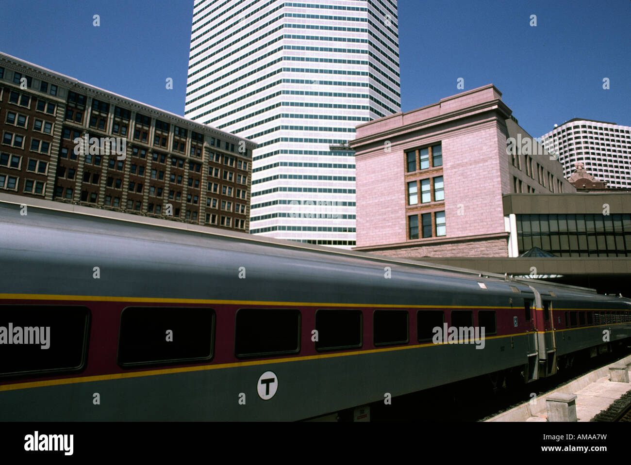 A commuter train sits idle at the boarding platform at South Station in ...