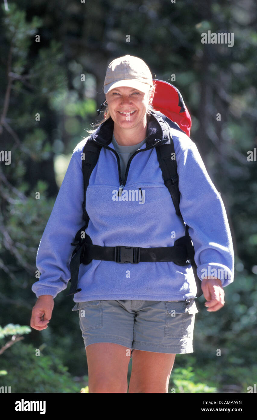 Woman Walking with Backpack Stock Photo - Alamy