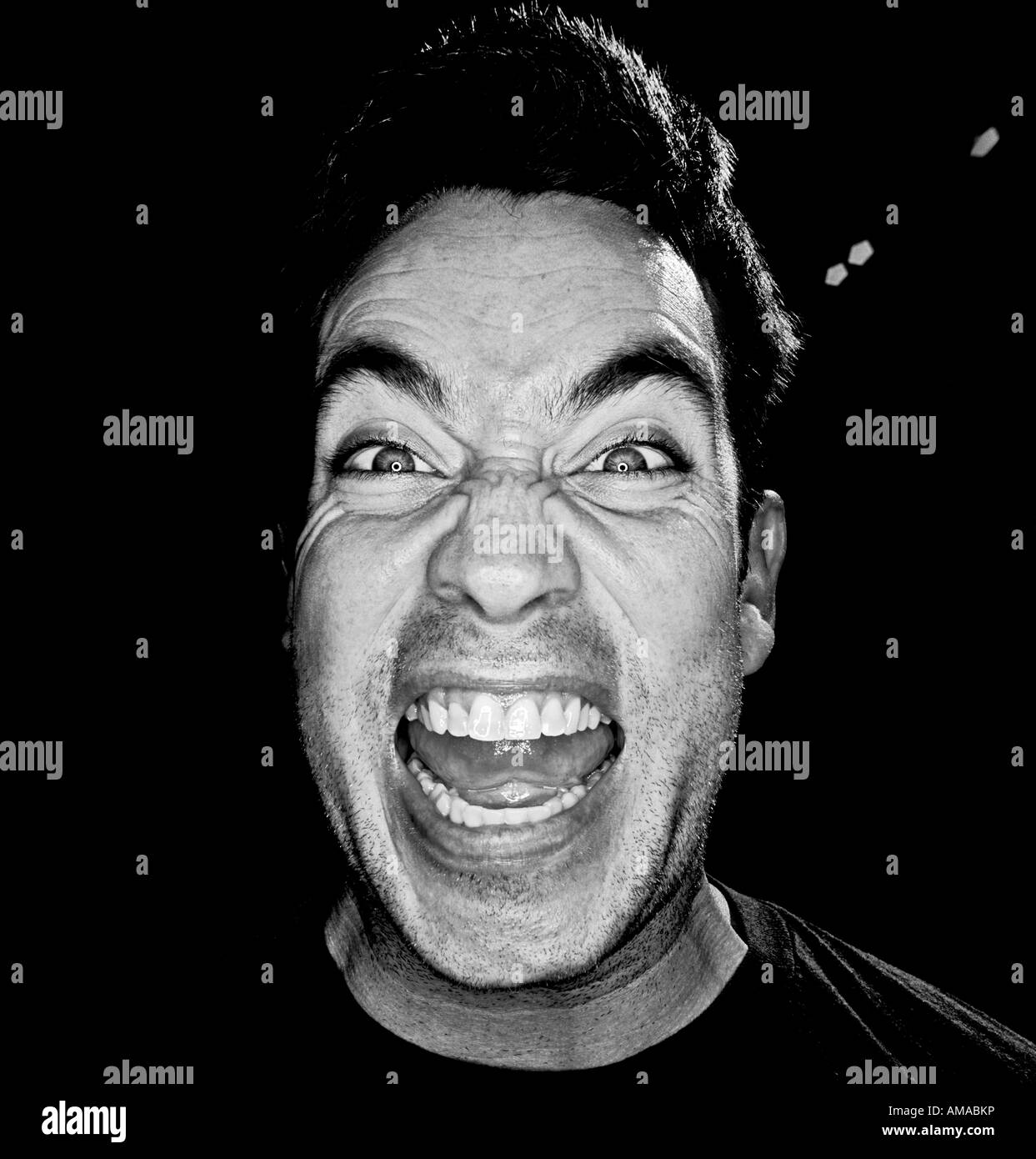 A 30-year-old man screams fiercely head-on, capturing raw emotion and ...