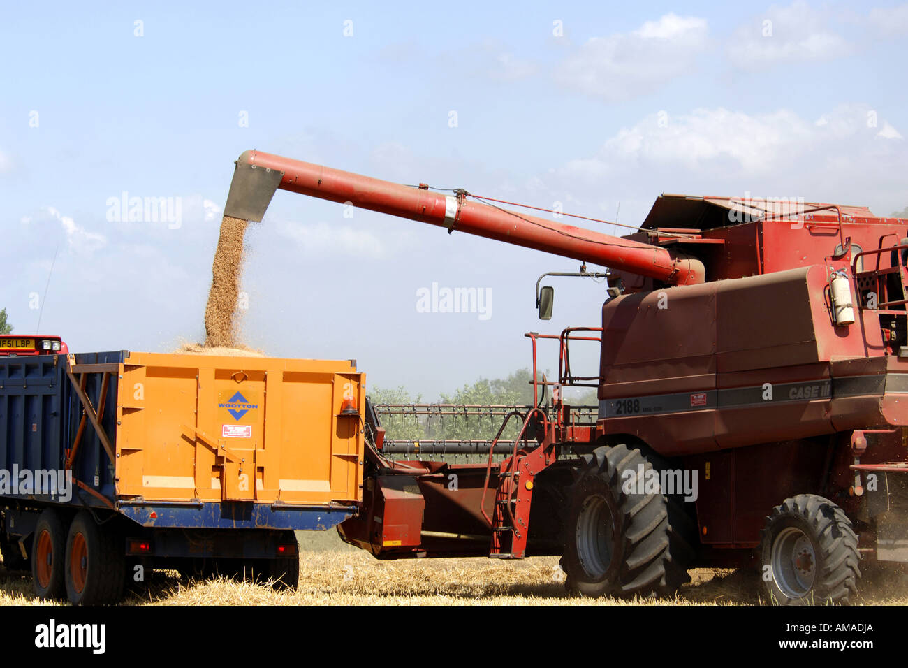 Transferring the crops from the Harvester to waiting Tractor and ...