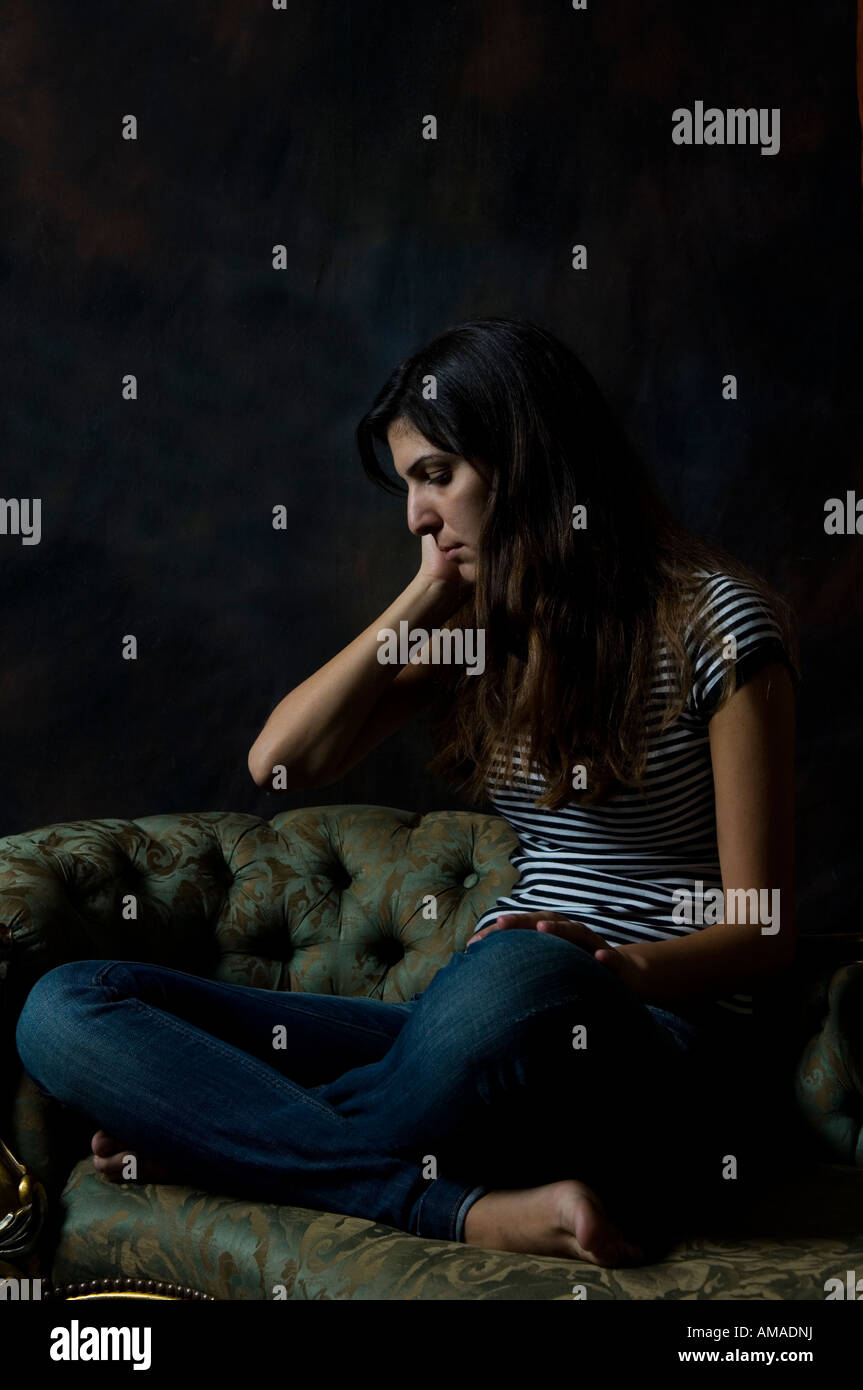 Sad girl sitting cross legged hi-res stock photography and images - Alamy