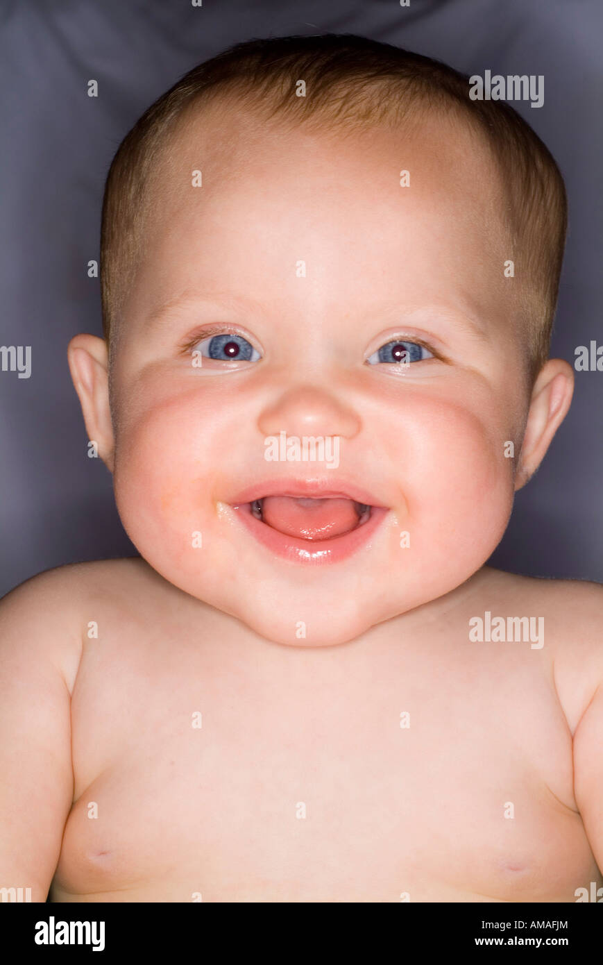 baby girl smiling at camera Stock Photo - Alamy