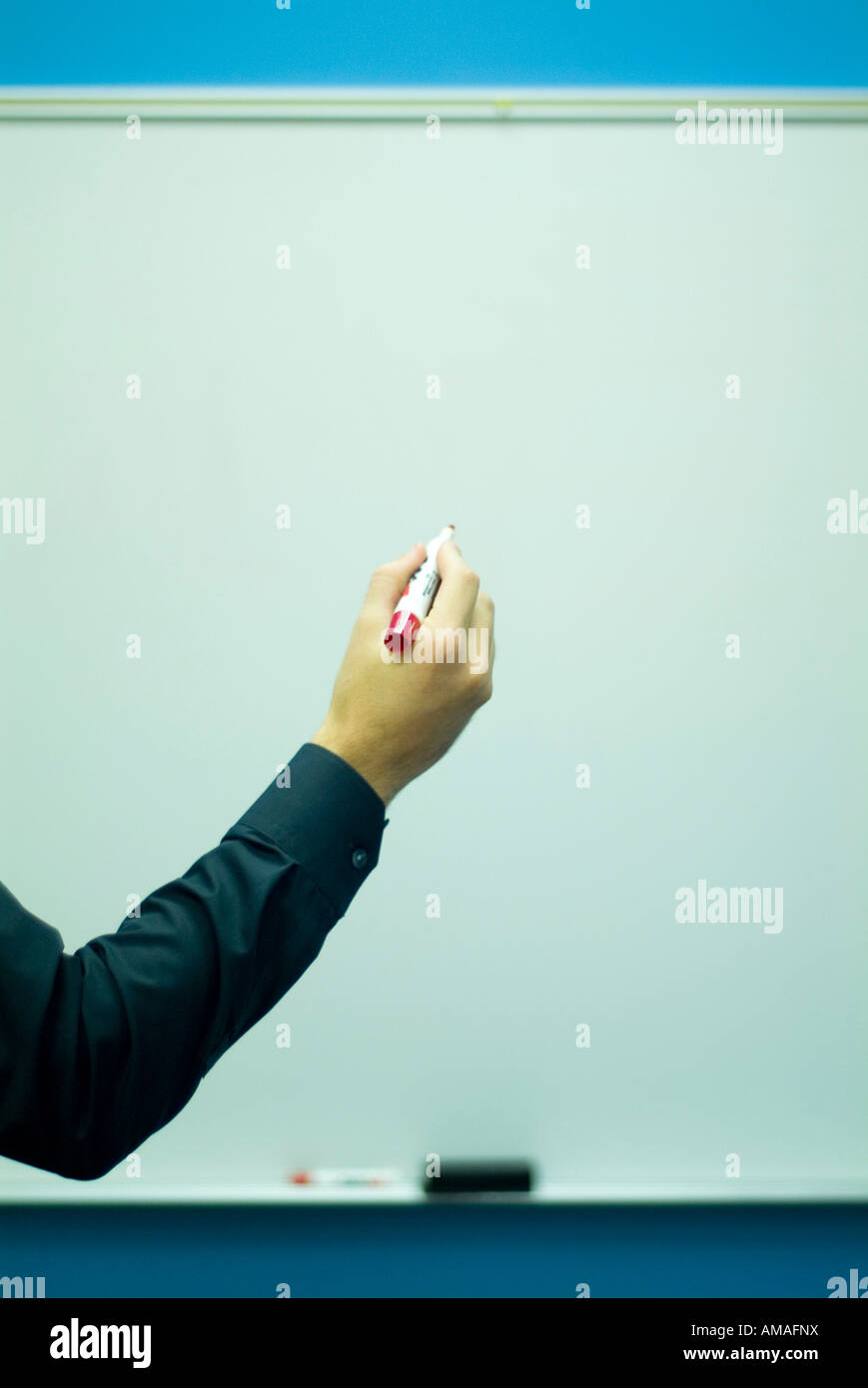 hand holding pen about to write on white board Stock Photo - Alamy