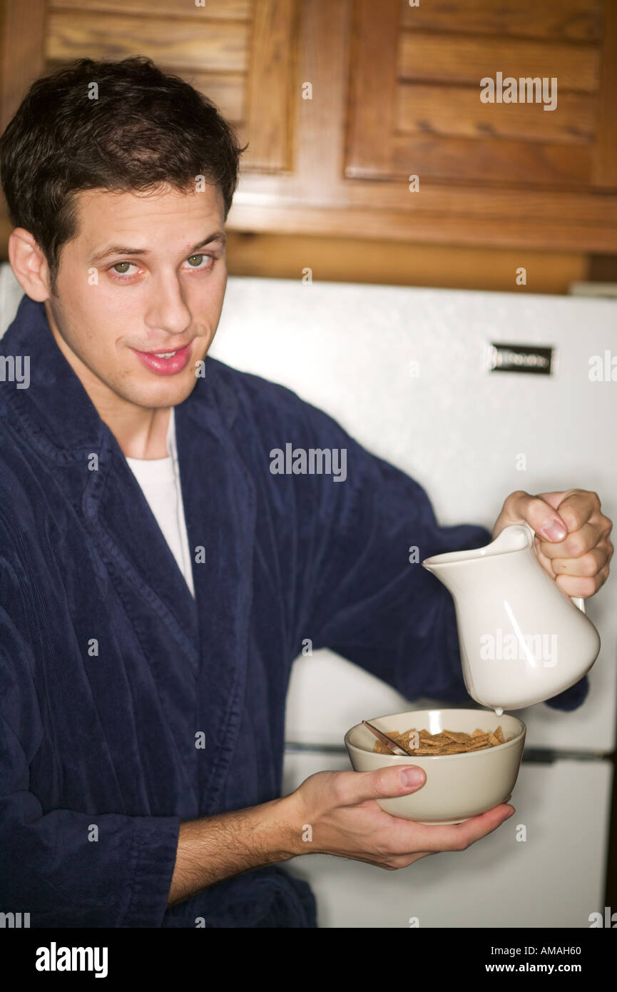 Man pouring milk onto cereal Stock Photo - Alamy
