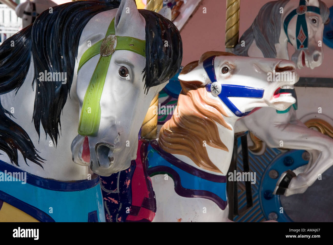 Painted horses on an amusement park carrousel Stock Photo - Alamy