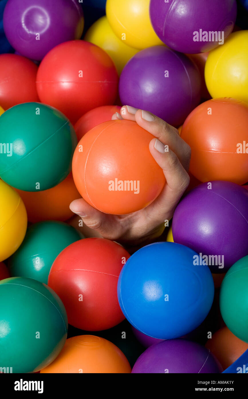 A hand emerging from ball pit Stock Photo - Alamy