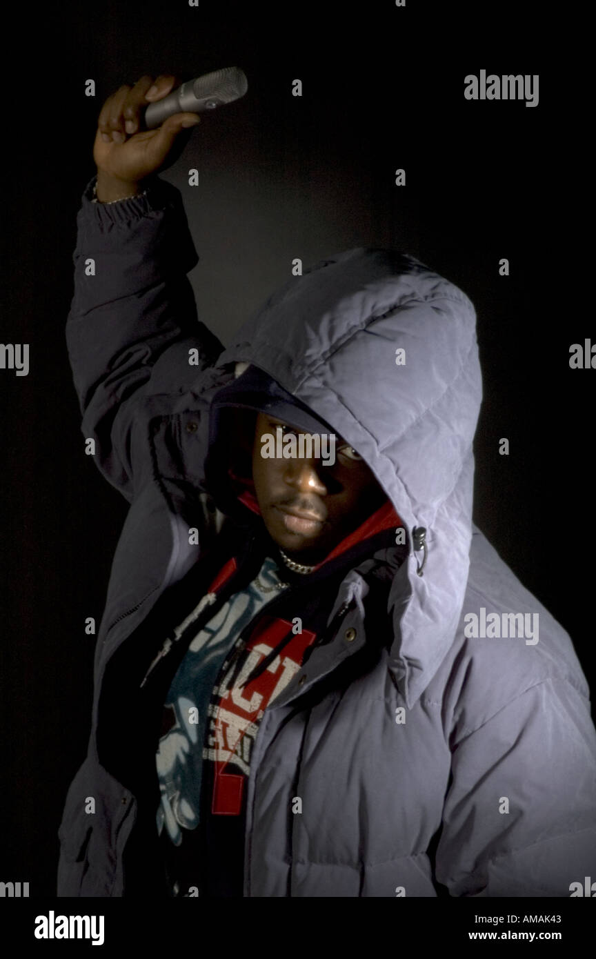 A young black male with what looks like a weapon but a mic to speak out ...