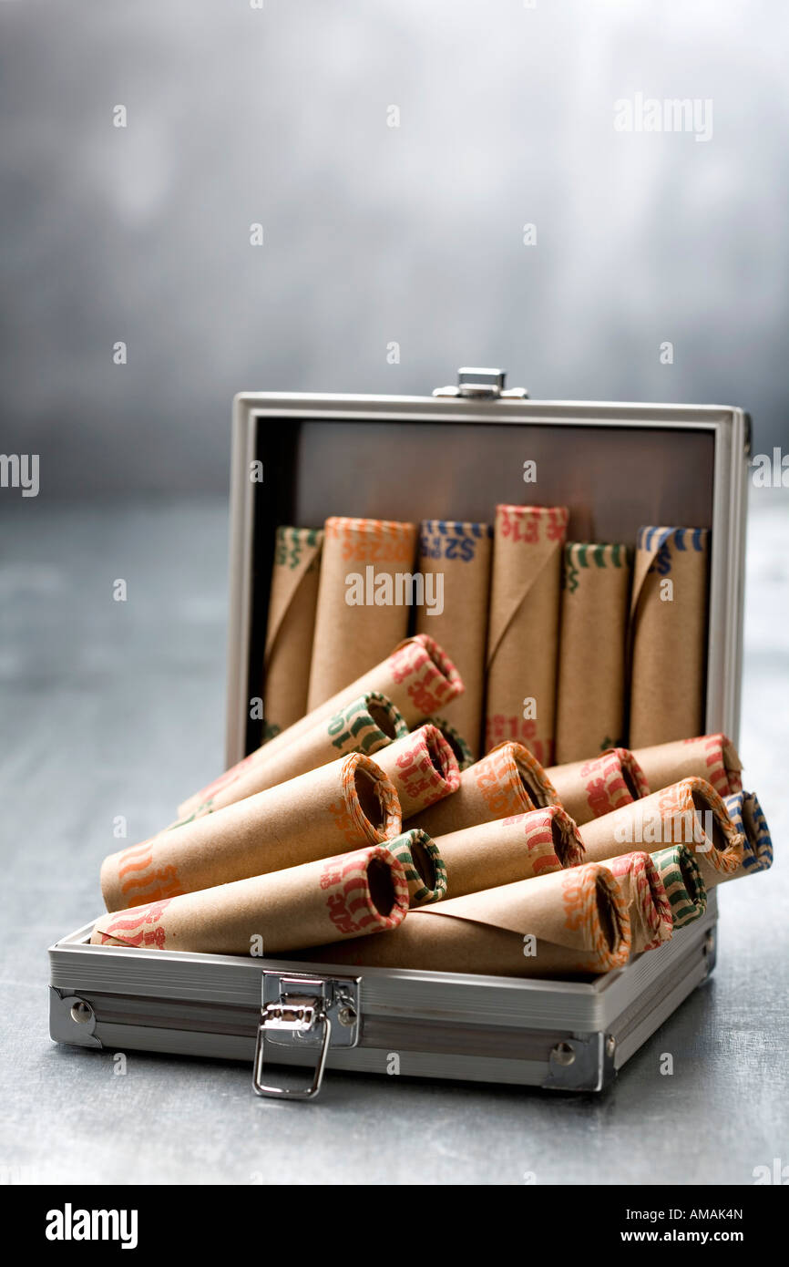 Coins rolled up in paper Stock Photo - Alamy