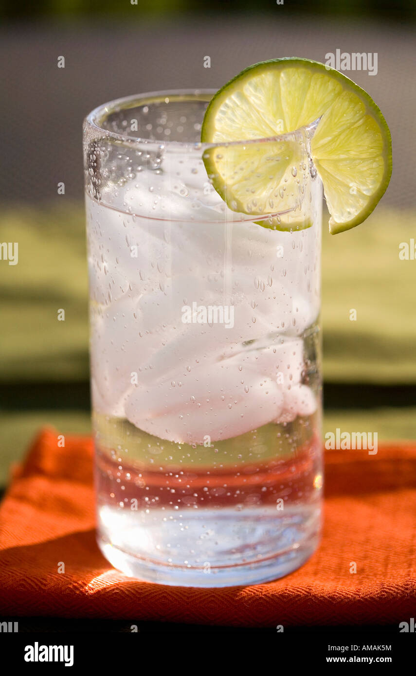 A cold drink with a slice of lime Stock Photo - Alamy