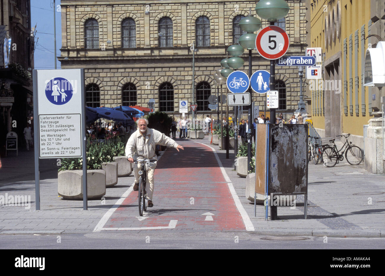 Germany Munich cyclist using a hand signal to indicate that he is ...