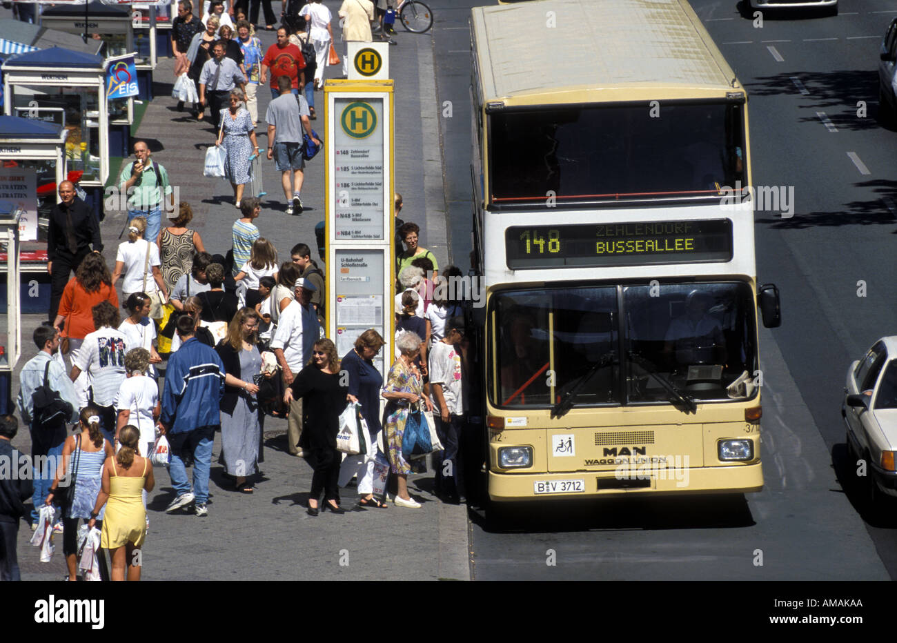 Germany Berlin crowds of people getting on and of a bus at a bus stop ...