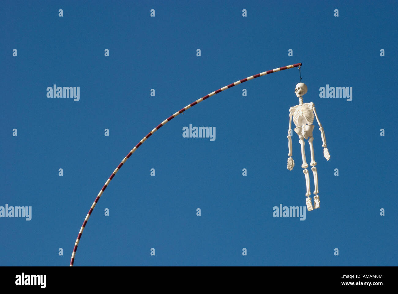 A toy skeleton hanging from a pole Stock Photo - Alamy