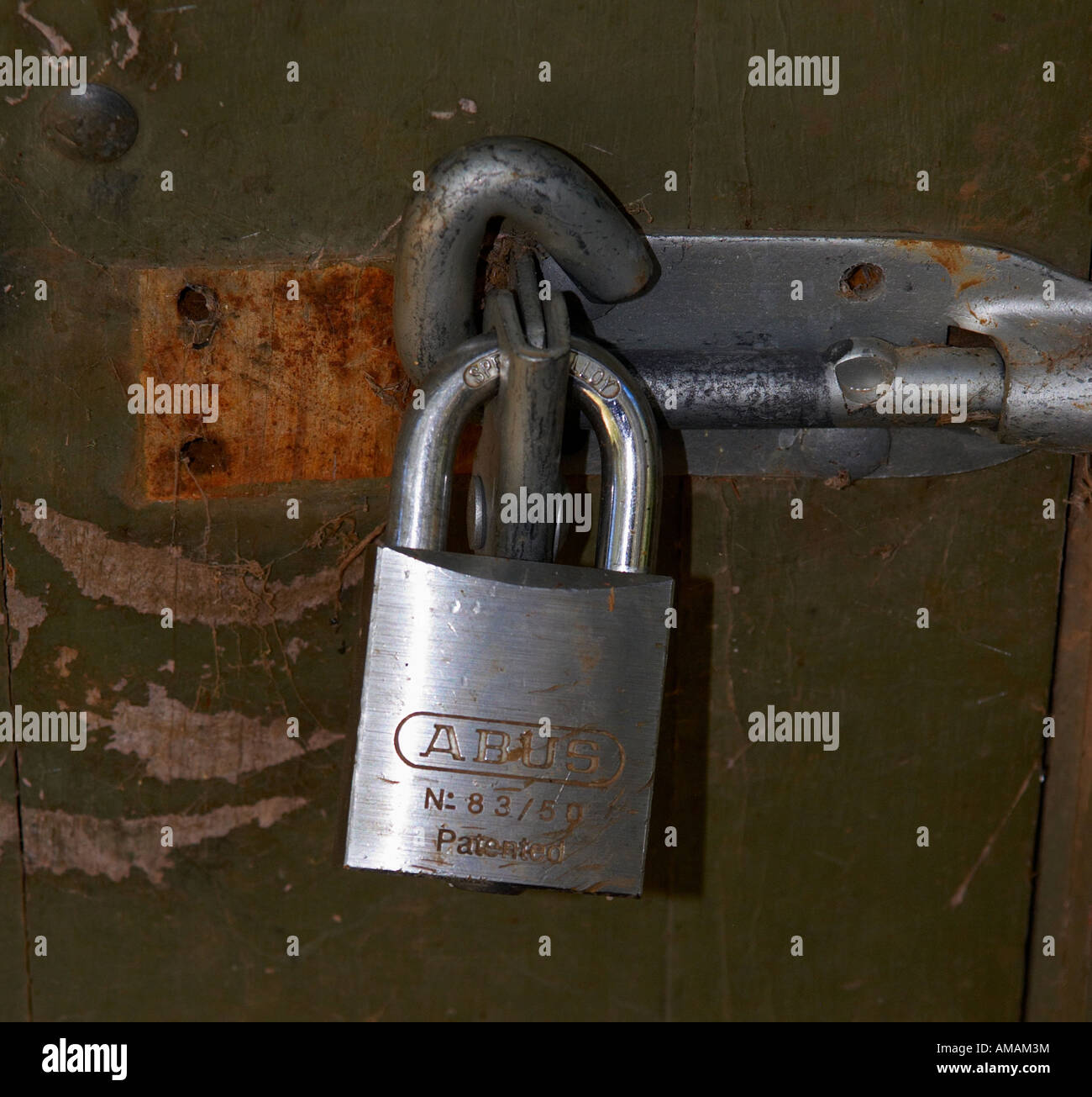 A pad lock on a pad bolt on a door Stock Photo - Alamy