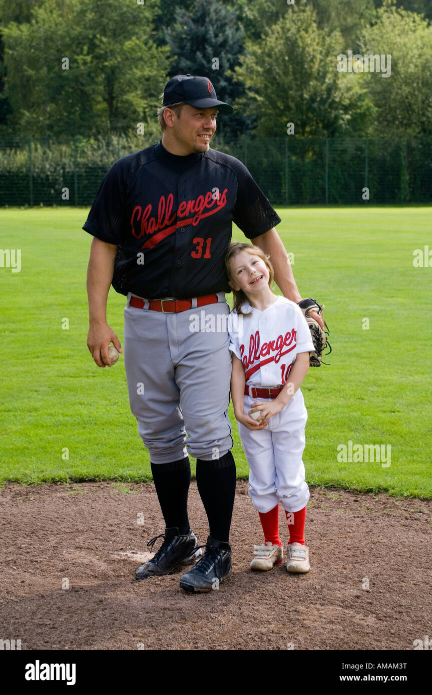 A baseball player standing with his daughter Stock Photo - Alamy