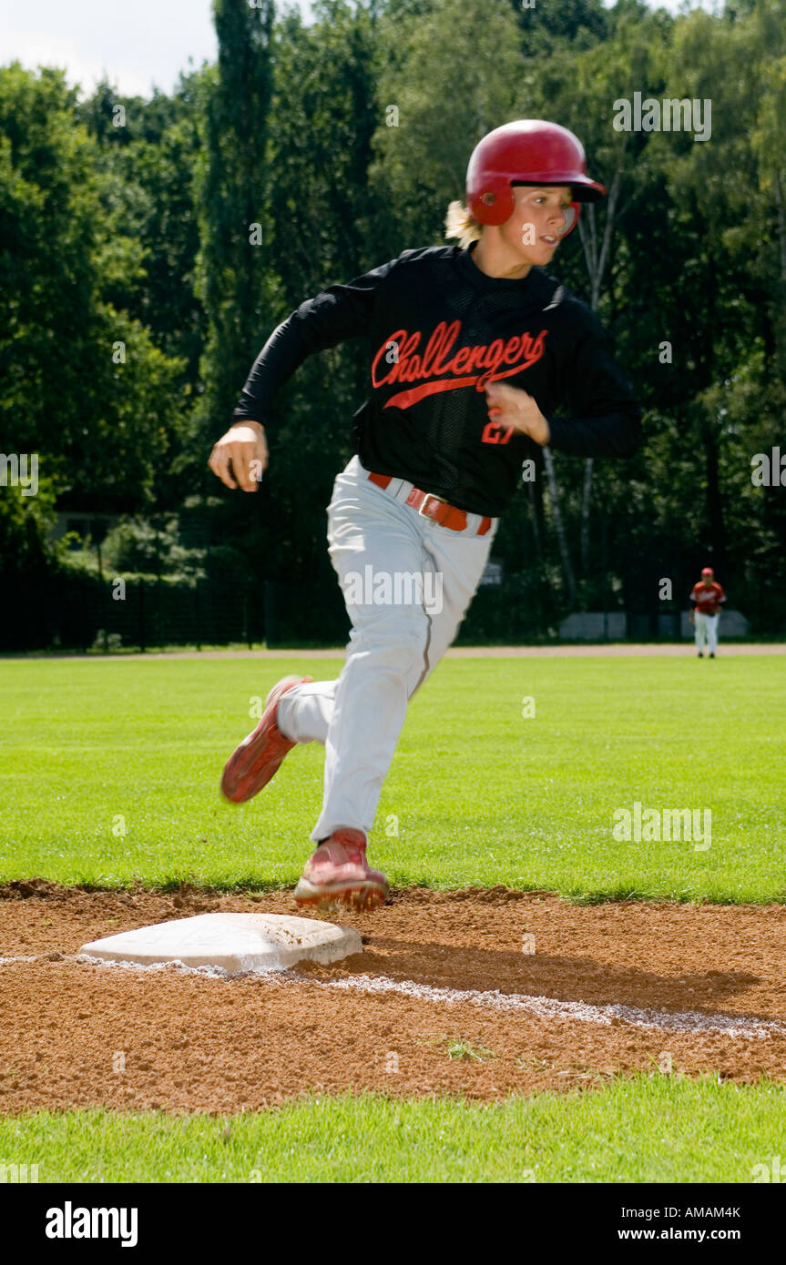 A baseball player running over a base Stock Photo - Alamy
