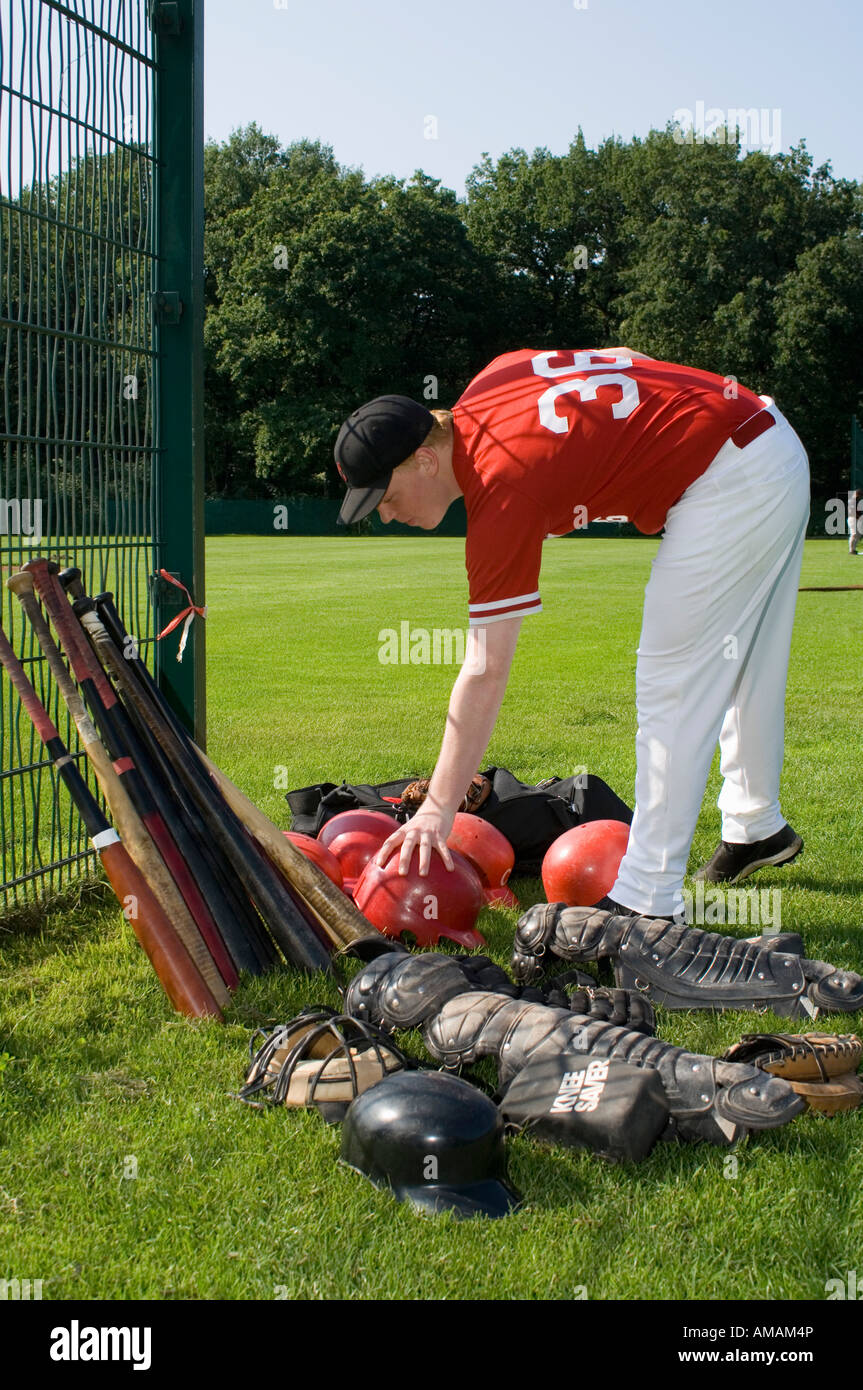 A baseball player picking up a helmet Stock Photo - Alamy