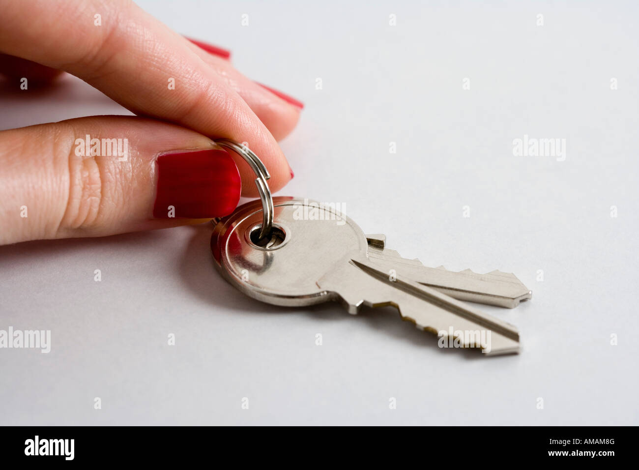 A woman holding keys Stock Photo - Alamy