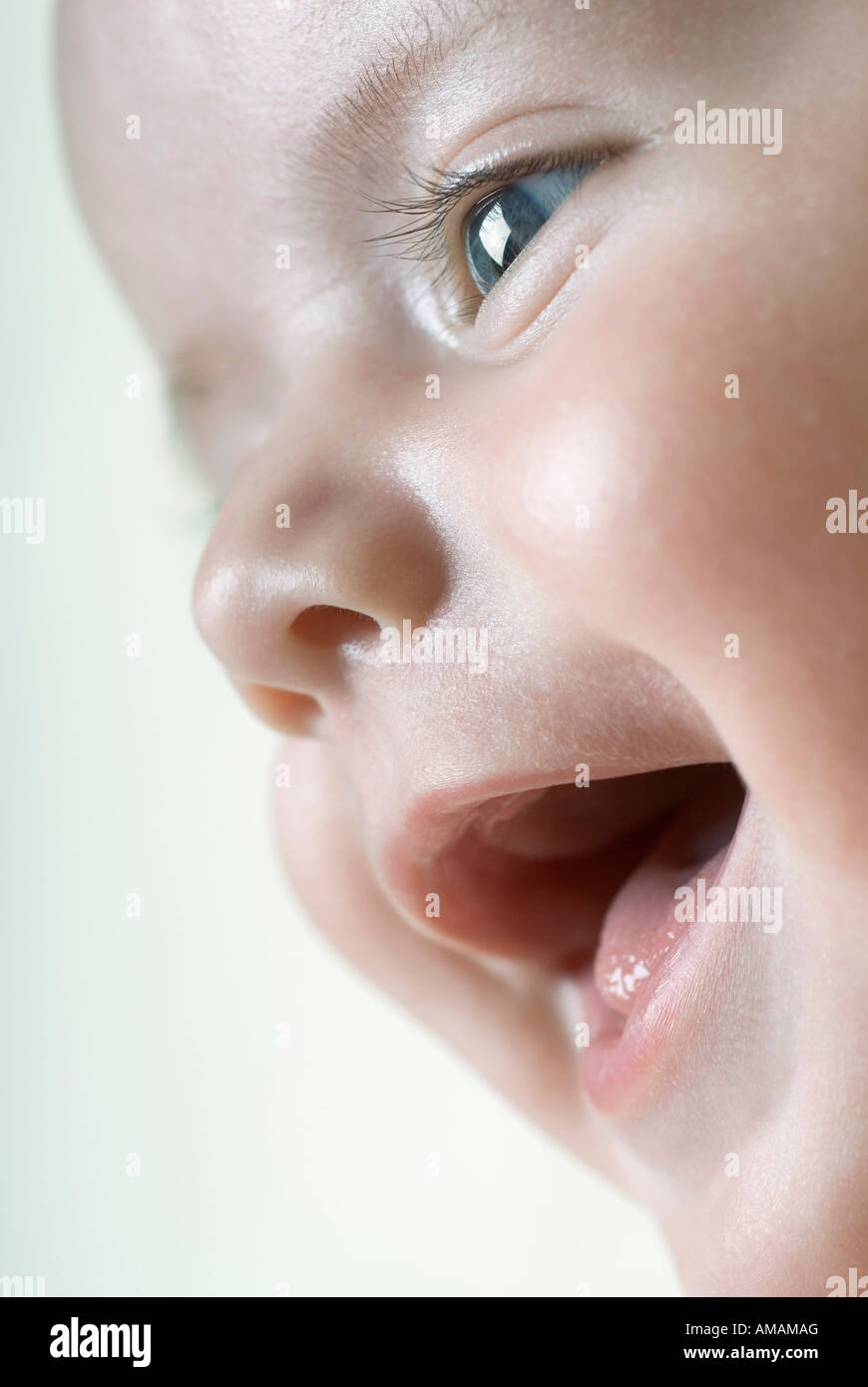 Side view of a baby laughing Stock Photo - Alamy