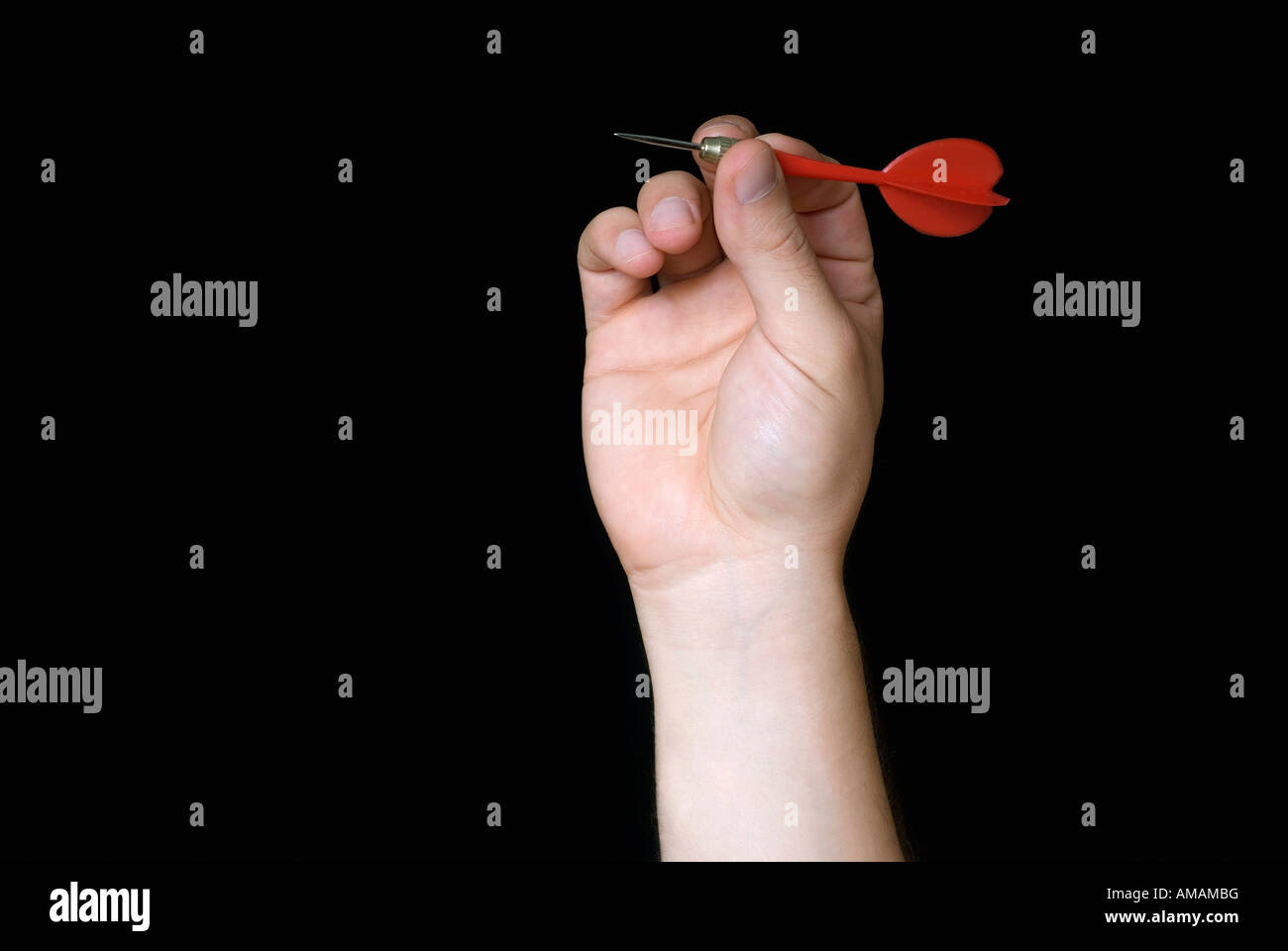 Hand holding a dart Stock Photo - Alamy