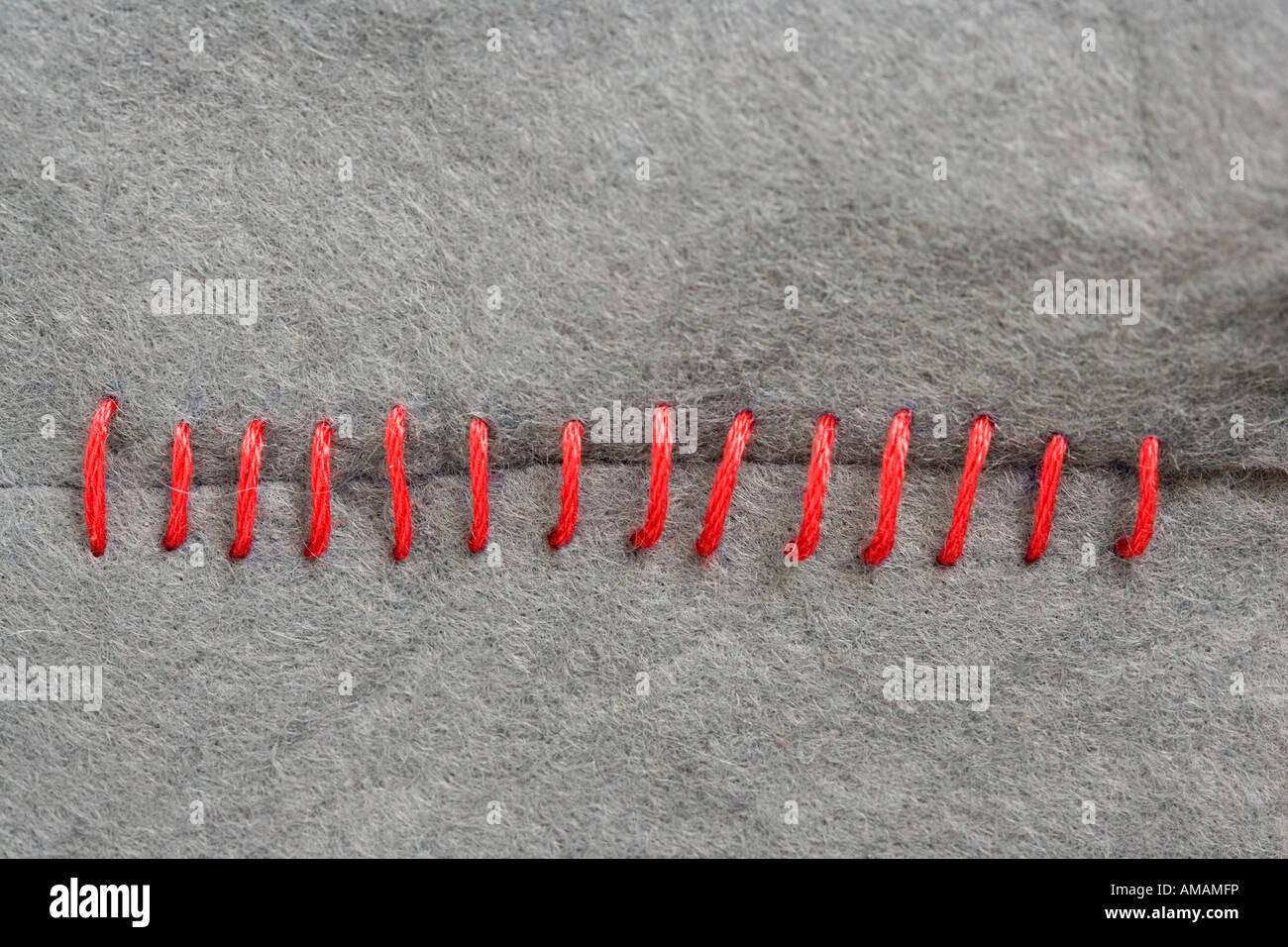 Red stitching on gray fabric Stock Photo - Alamy