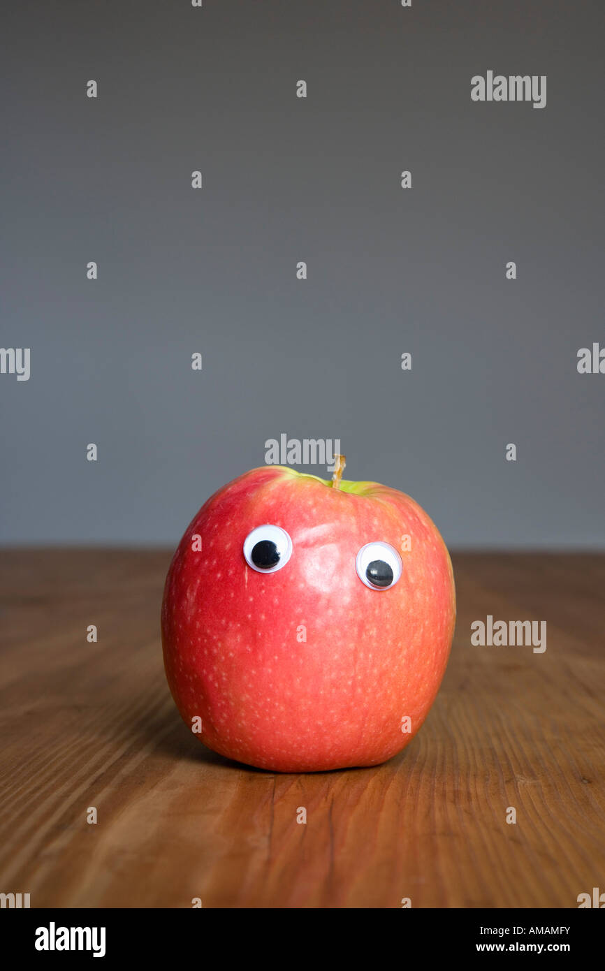 A red apple with eyes Stock Photo - Alamy