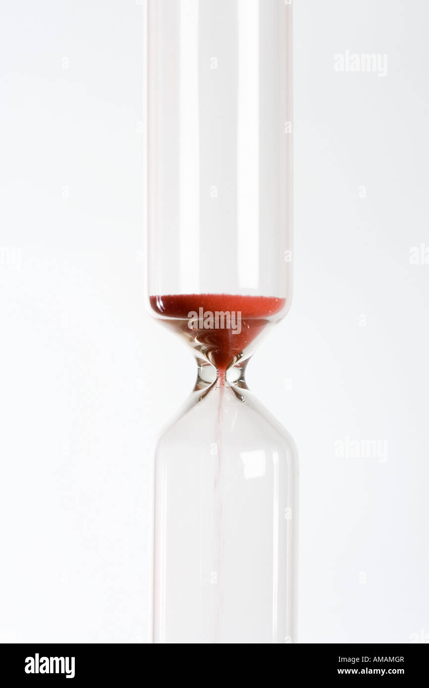 Sand falling through an hourglass Stock Photo - Alamy
