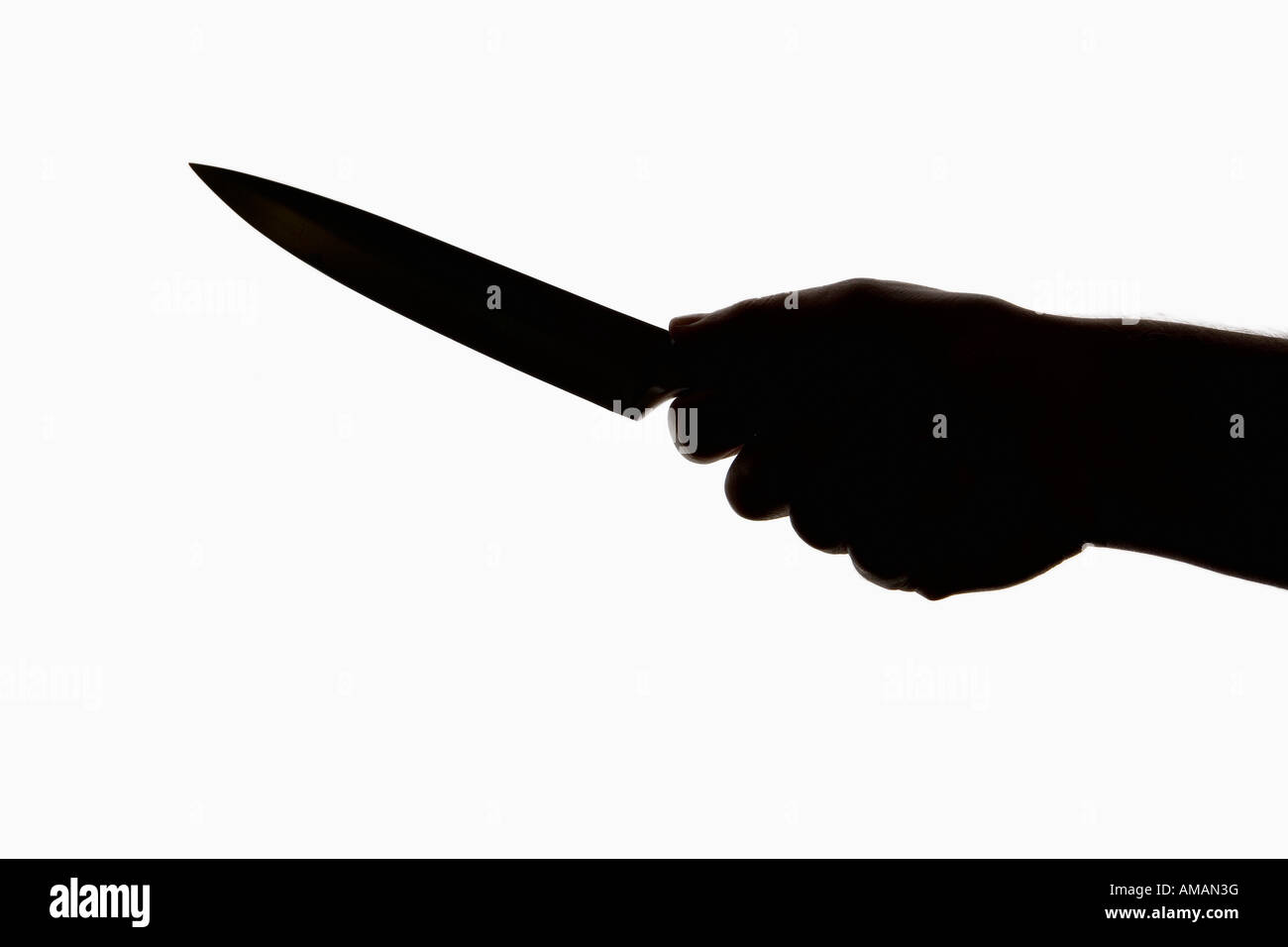 A silhouette of a hand holding a knife Stock Photo - Alamy