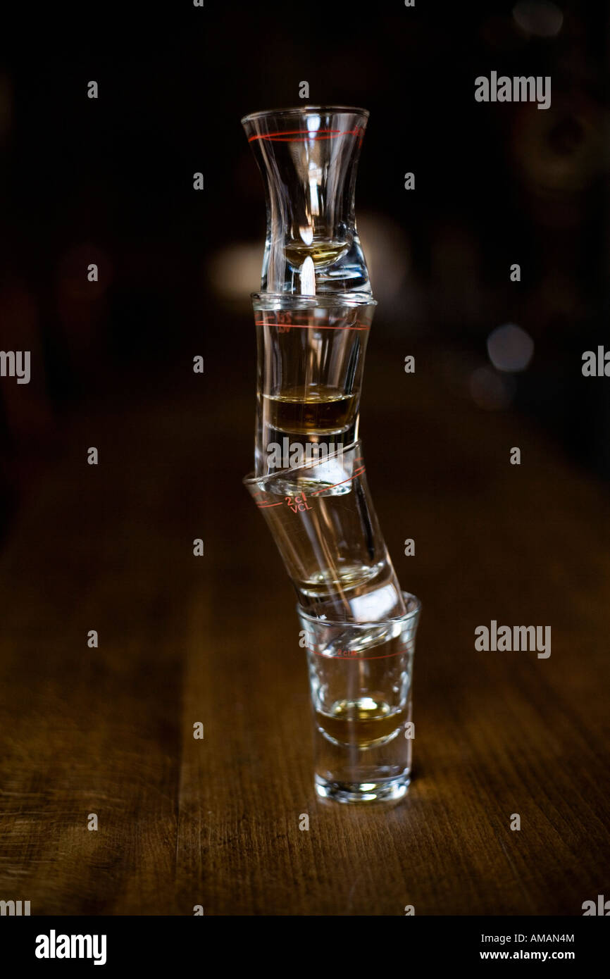 A stack of empty shot glasses Stock Photo - Alamy