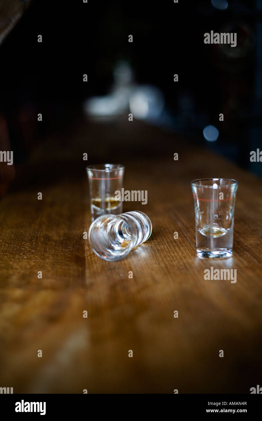 Three empty shot glasses on a bar Stock Photo - Alamy
