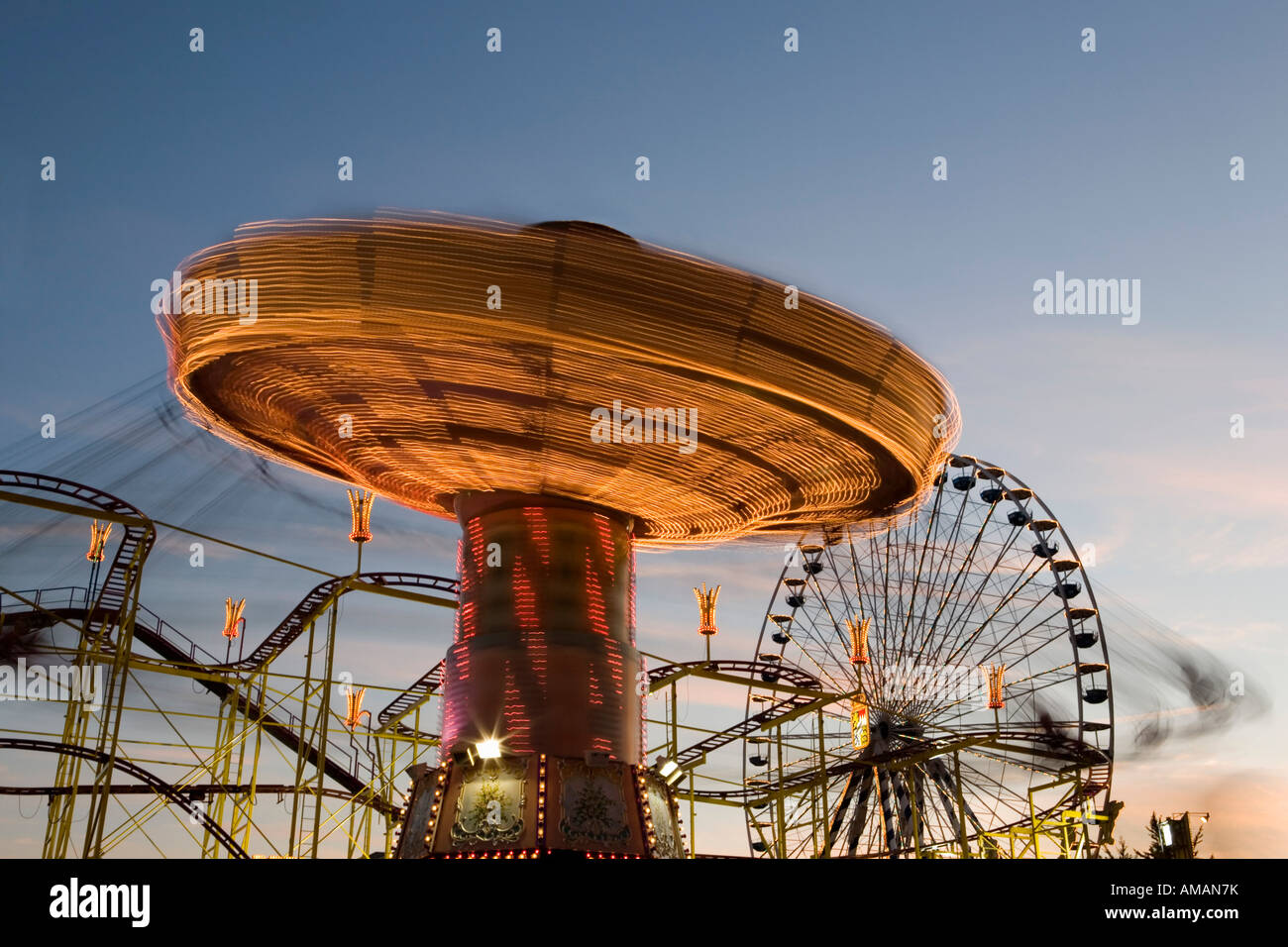 A fairground at dusk Stock Photo - Alamy