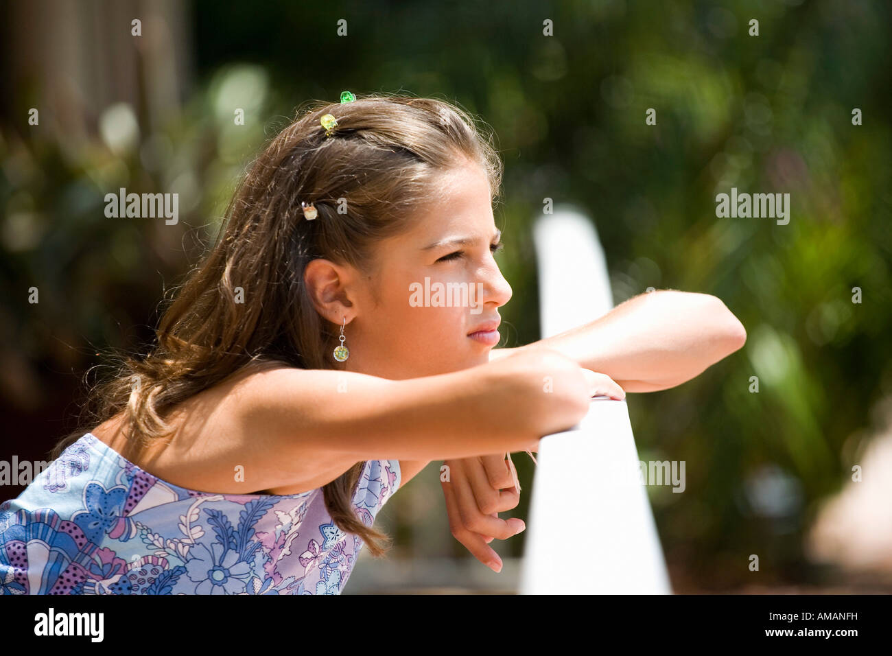 A young girl leaning on railing Stock Photo - Alamy