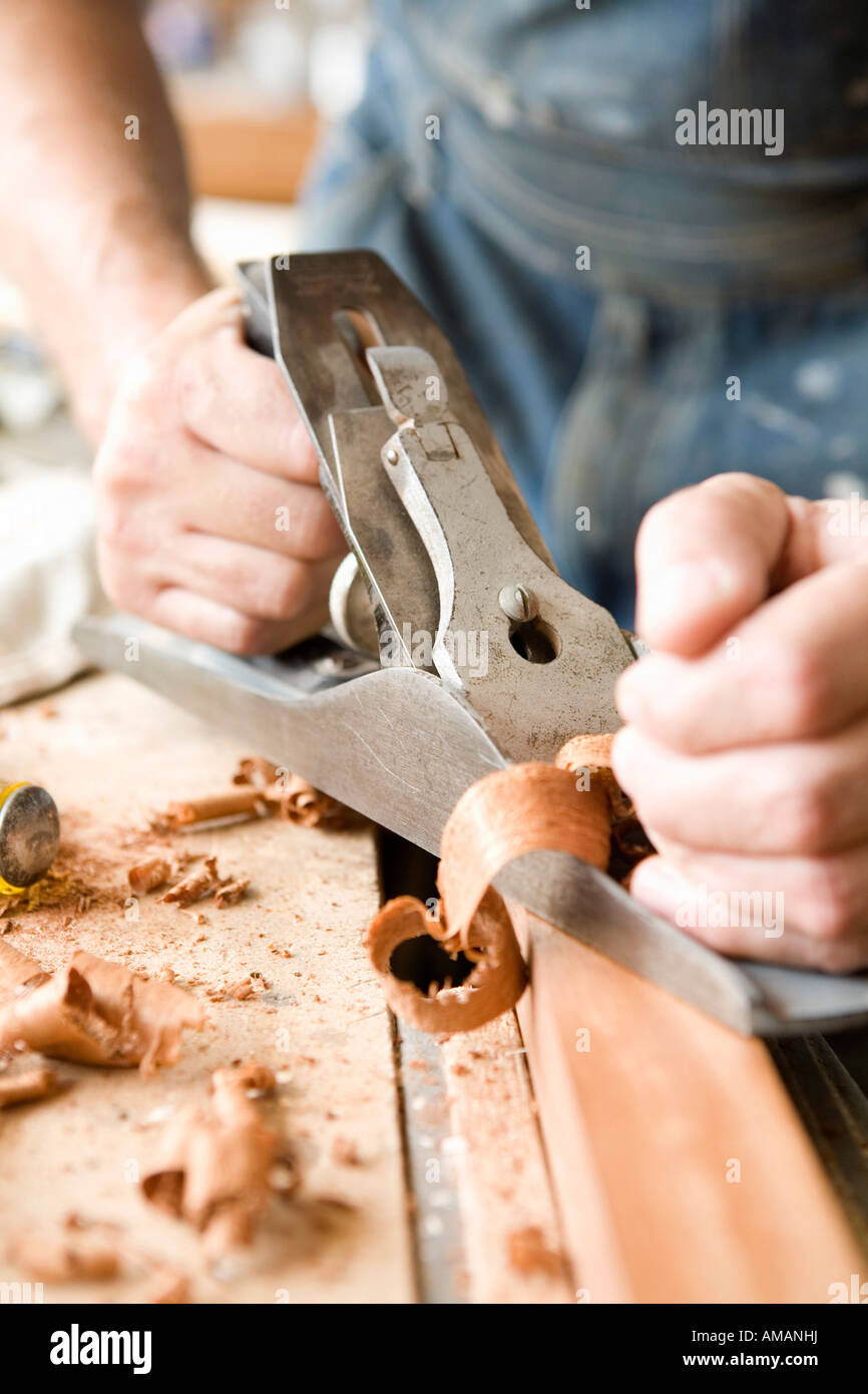 Detail of a carpenter planning wood Stock Photo - Alamy