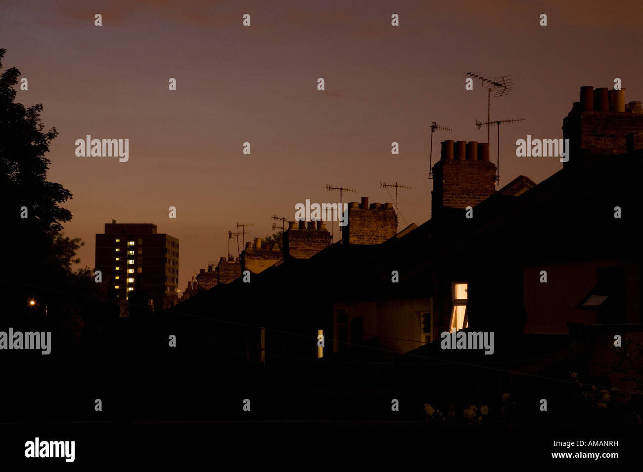 Row houses and an apartment block at night Stock Photo - Alamy