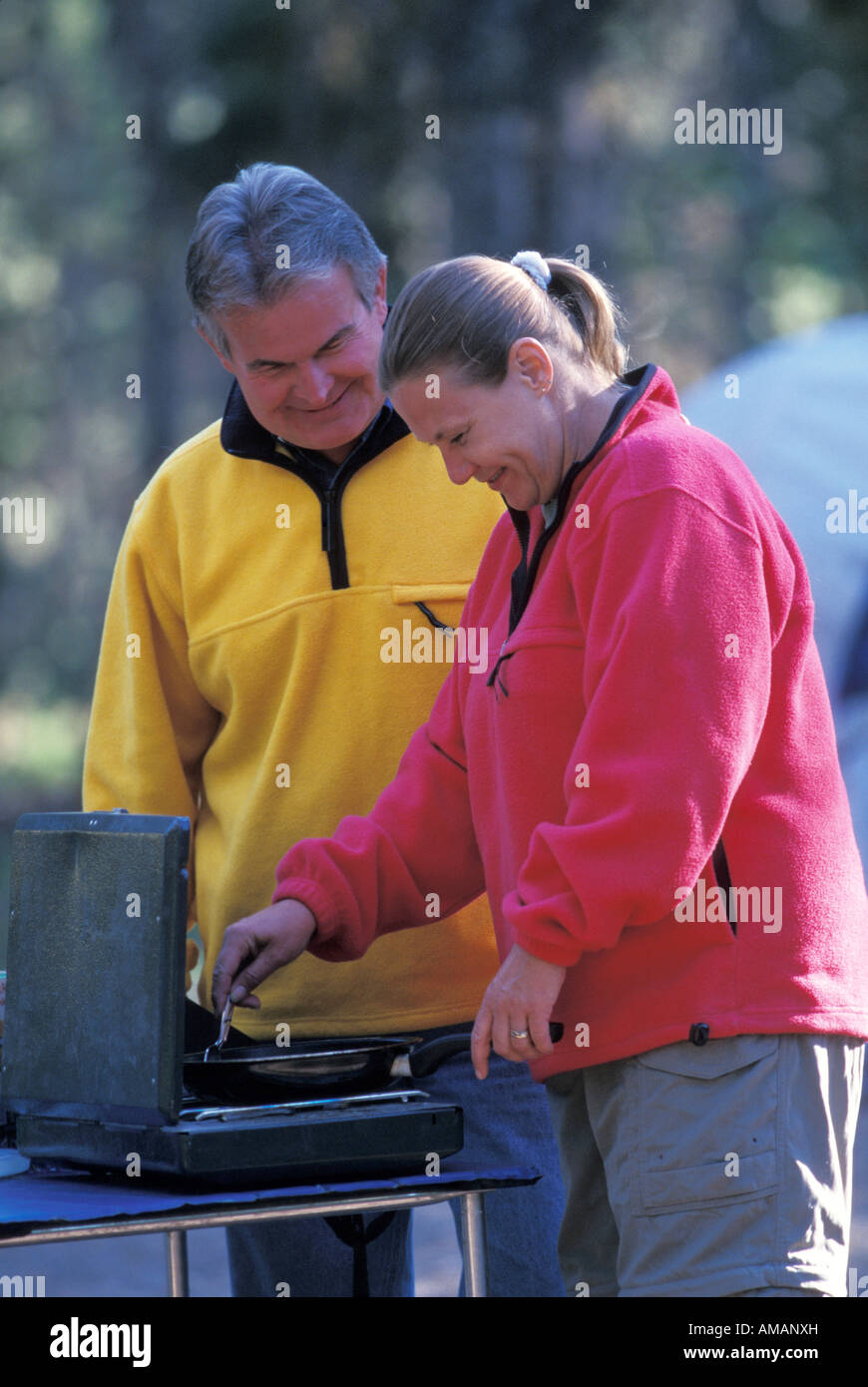 Couple Cooking Outdoors Stock Photo - Alamy