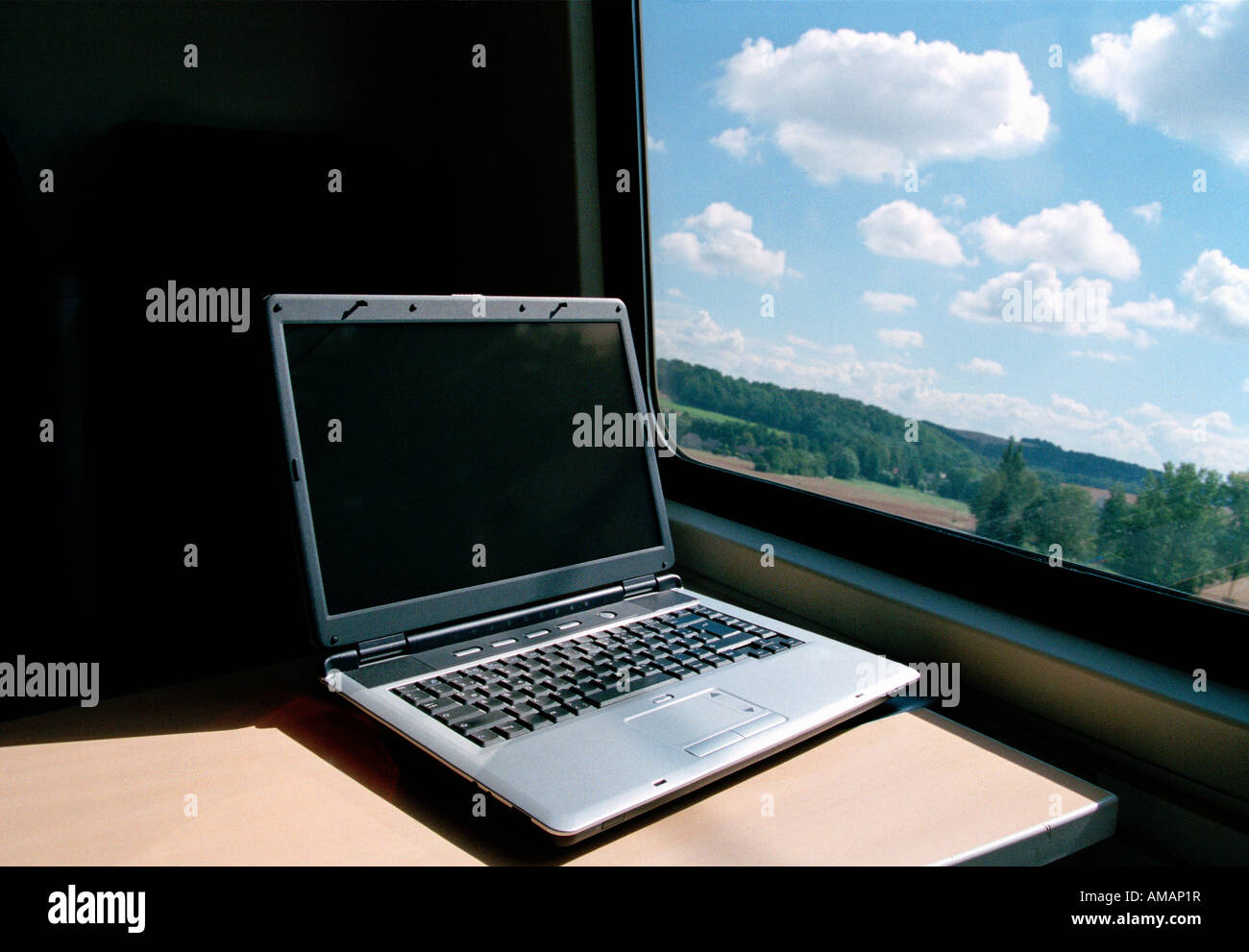 A laptop on a table in a train carriage Stock Photo - Alamy