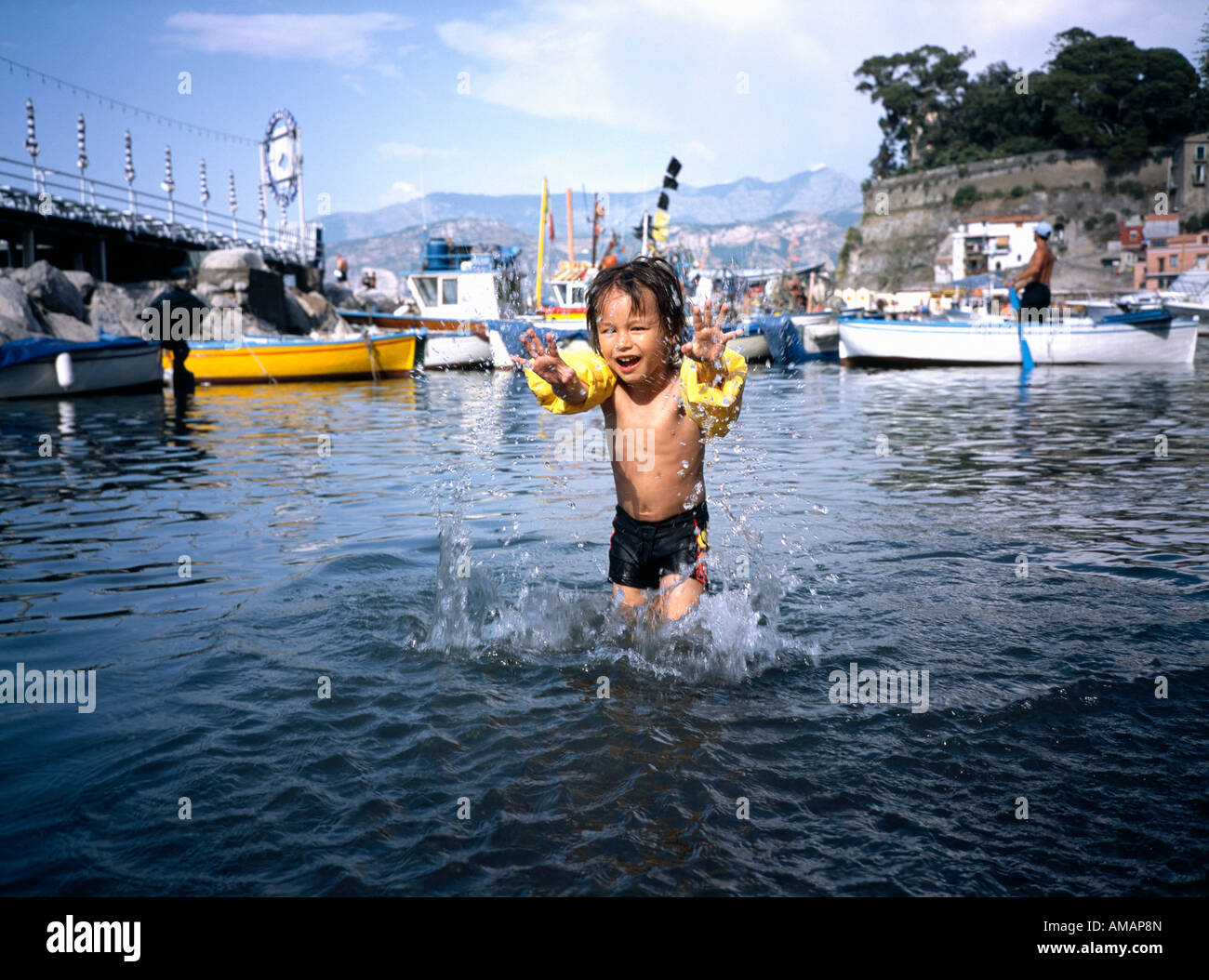 A boy splashing in the sea Stock Photo - Alamy