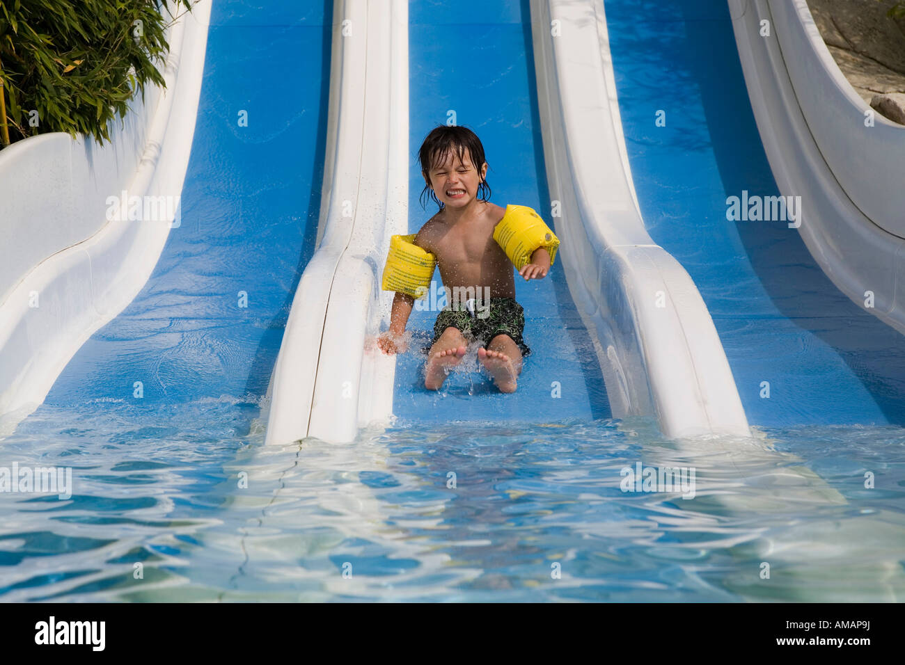 A boy on a water slide Stock Photo - Alamy