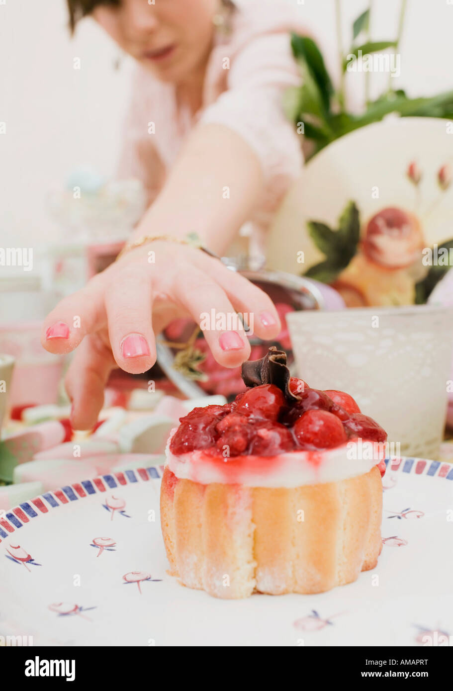 Hand reaching cake hi-res stock photography and images - Alamy