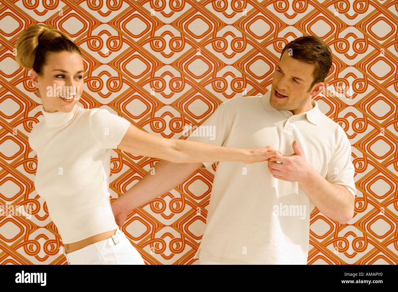 Young couple standing, holding hands Stock Photo - Alamy